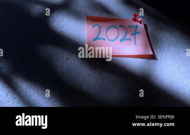 Handwritten 2027 On Pink Sticky Note With Swaying Sunlight Shadows ...