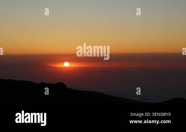 Warm sunset colors above the sea of clouds viewed from Teide National ...