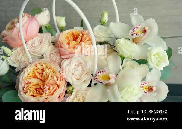 A beautiful romantic bouquet of unusual white roses in a handbag. A ...
