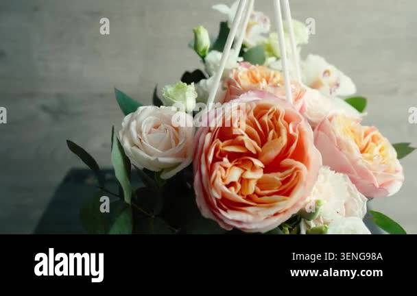 A beautiful romantic bouquet of unusual white roses in a handbag. A ...