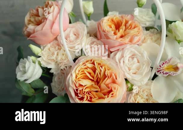 A beautiful romantic bouquet of unusual white roses in a handbag. A ...