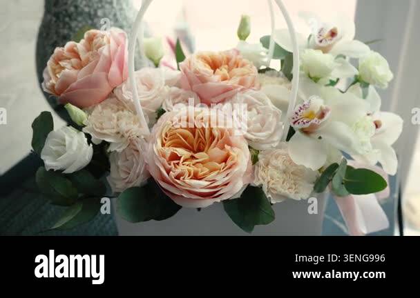 A beautiful romantic bouquet of unusual white roses in a handbag. A ...