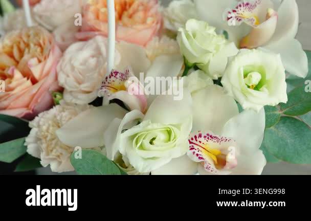 A beautiful romantic bouquet of unusual white roses in a handbag. A ...