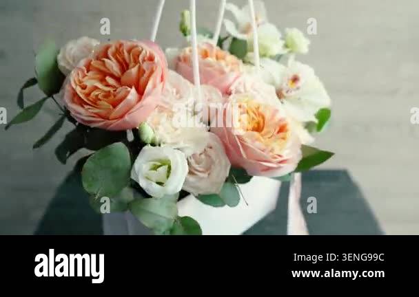 A beautiful romantic bouquet of unusual white roses in a handbag. A ...