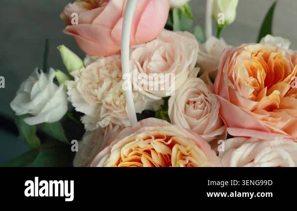 A beautiful romantic bouquet of unusual white roses in a handbag. A ...