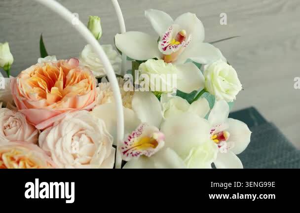 A beautiful romantic bouquet of unusual white roses in a handbag. A ...