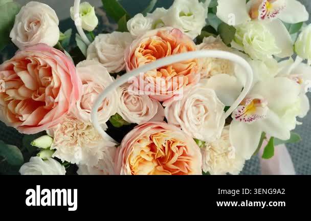 A beautiful romantic bouquet of unusual white roses in a handbag. A ...