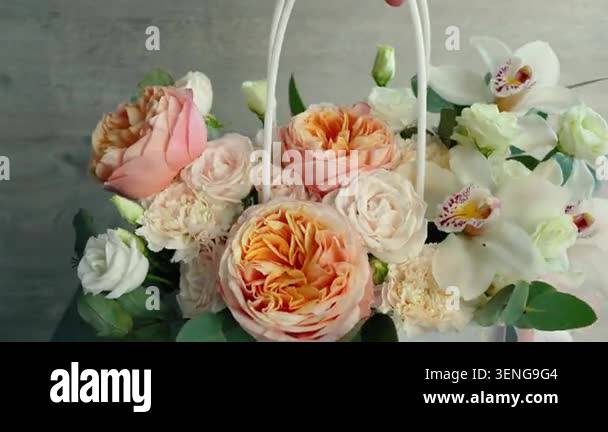 A beautiful romantic bouquet of unusual white roses in a handbag. A ...