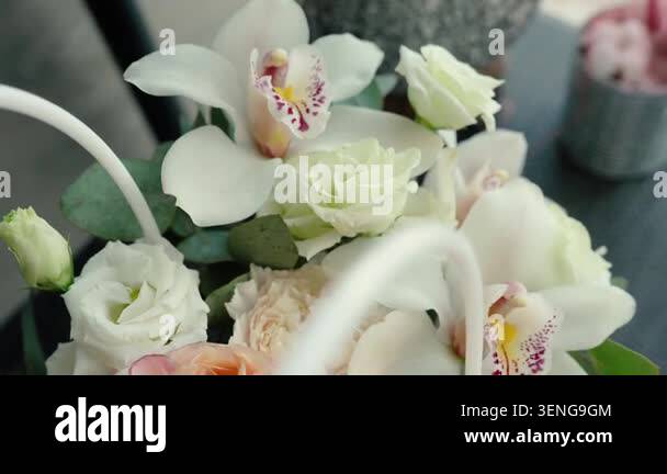 A beautiful romantic bouquet of unusual white roses in a handbag. A ...