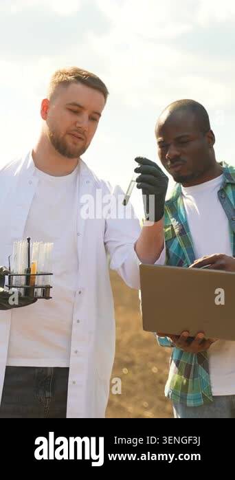 Two diverse male specialists, a laboratory scientist and a farmer ...
