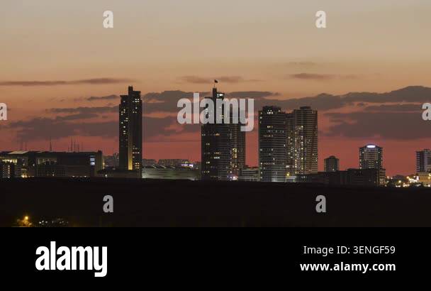 Sunset footage between the city and buildings. Dance of clouds above ...
