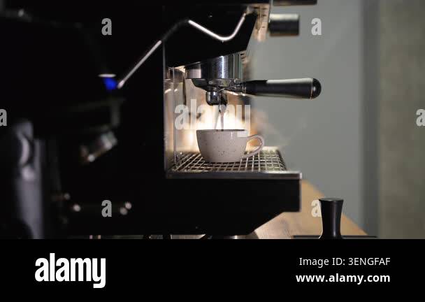 Professional barista making a cup of aromatic espresso. Hot coffee ...
