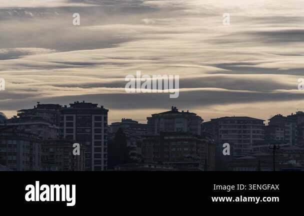 Sunset footage between the city and buildings. Dance of clouds above ...