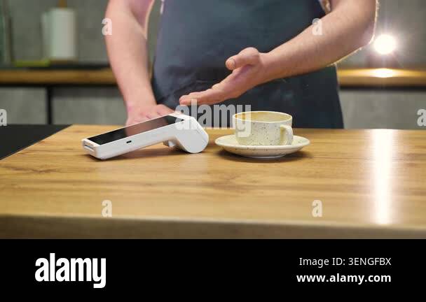 Customer paying for coffee with a credit card at a cafe. Barista ...