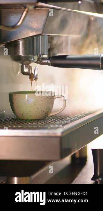 Close up view of a professional espresso machine pouring a hot double ...