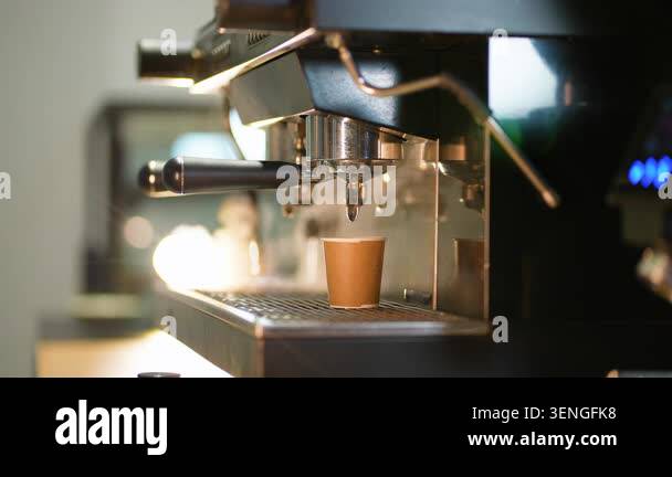 Professional barista preparing a hot, steamy espresso shot. The coffee ...