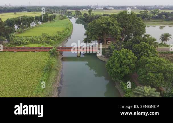 Tropical Rural Landscape With Calm Water Canal and rail over bridge ...
