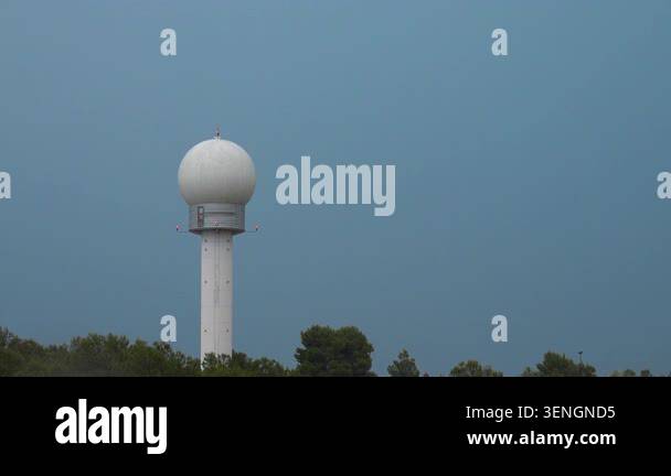 Telezoom to a large spherical white radar dome with a paneled surface ...
