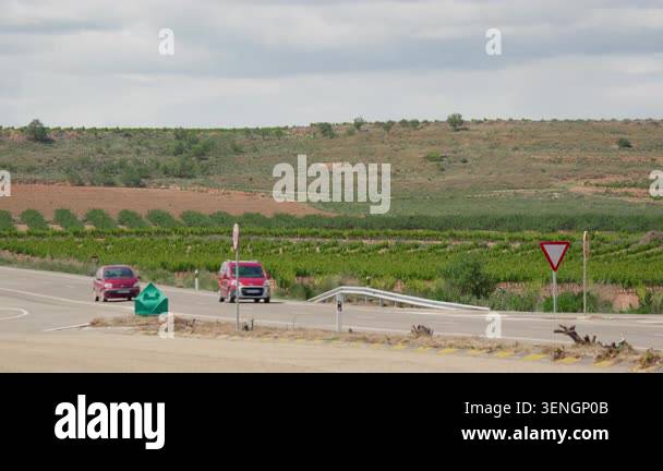 Refrigerated semi truck and a white van travel along a rural highway ...