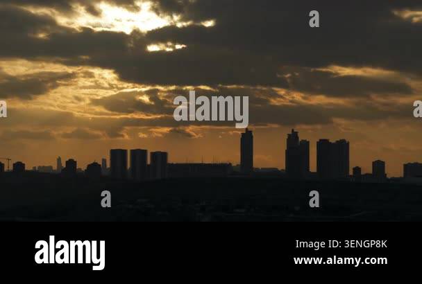 Sunset footage between the city and buildings. Dance of clouds above ...