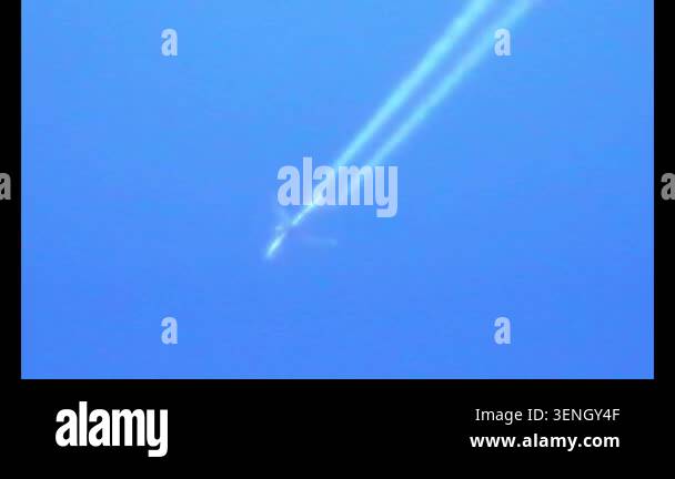 retro vintage airplane flying in clear blue summer sky with contrails ...