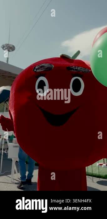 Chisinau, Moldova - June 1, 2026 Marathon. Red tomato mascot character ...