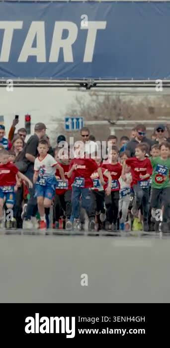 Chisinau, Moldova - June 1, 2026 Marathon. Children in red shirts run ...