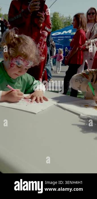 Chisinau, Moldova - June 1, 2026 Marathon. Two kids focus on drawing at ...