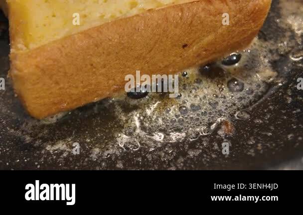Cooking a slice of French toast close-up cinematic view. Macro shot of ...