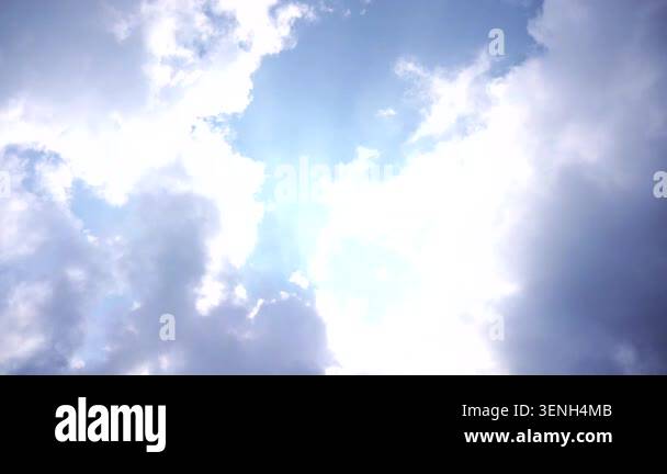 Time-lapse video of white clouds moving fast across a bright blue sky ...