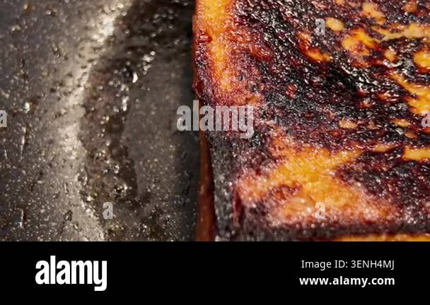 Cooking a slice of French toast close-up cinematic view. Macro shot of ...