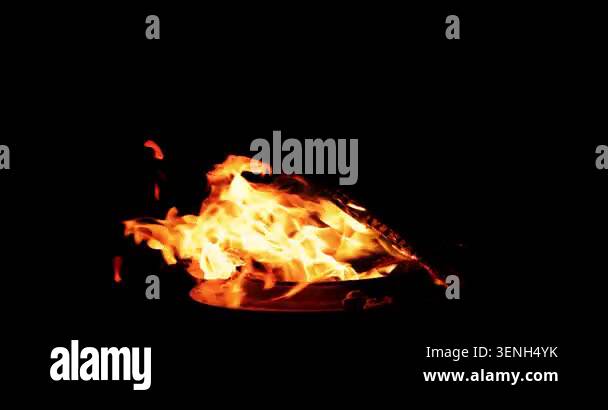 A static shot of a warm campfire fireplace with glowing flames and ...