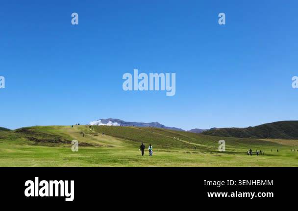 Wide shot of Kusasenri plateau at Mount Aso in Japan during spring ...