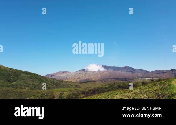 Panoramic view of Mount Aso volcano with smoke emitting from the active ...