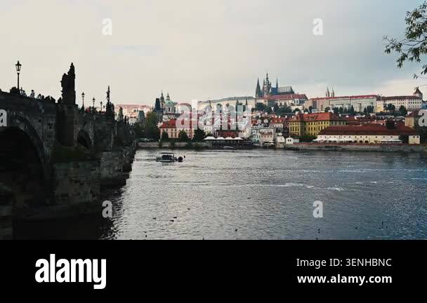 Prague Charles Bridge spans Vltava River. Prague Castle and historic ...