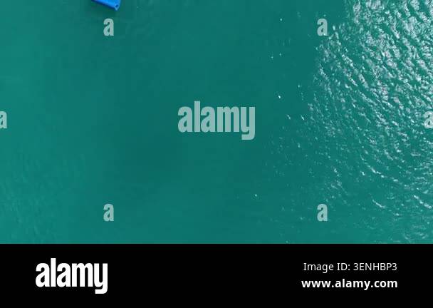 Aerial view of turquoise sea surface texture with a luxury white ...