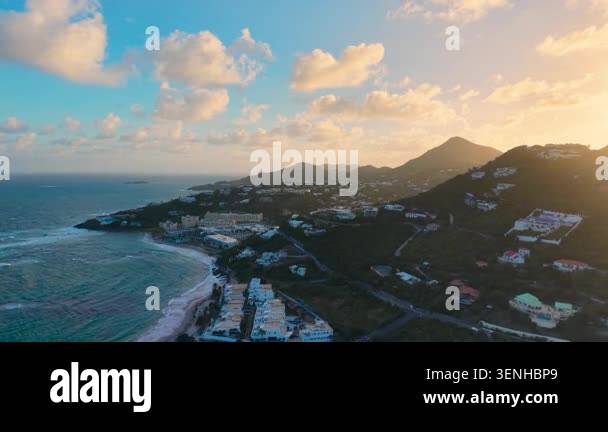 Aerial view of the resort coastline and lush green hills on the island ...