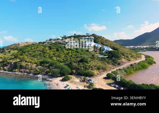 Aerial view of a scenic tropical hill with luxury villas on the French ...