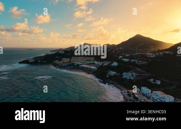 Aerial view of the resort coastline and lush green hills on the island ...