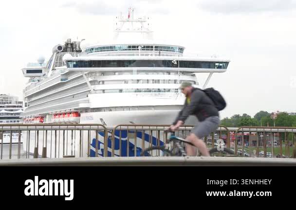 Massive white cruise liner docked at city port terminal with active ...