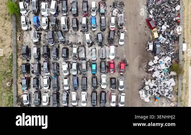 Aerial view of a densely packed car junkyard with rows of dismantled ...