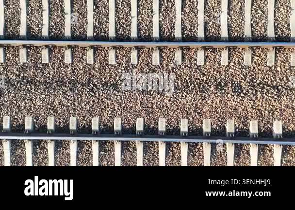 Aerial view of railway tracks showing continuous alignment of metal ...