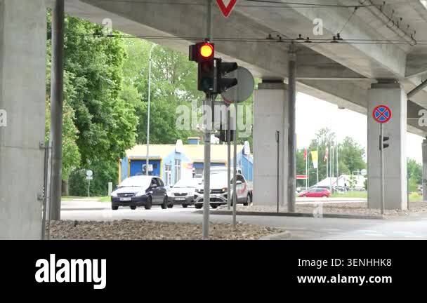 City traffic intersection under a concrete overpass bridge with a red ...