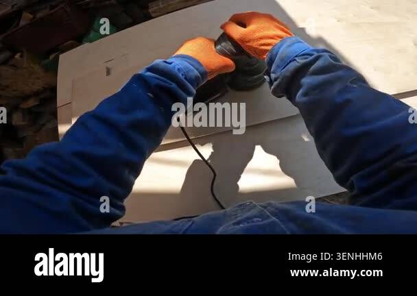 The master sands a wooden surface with an eccentric machine. The ...
