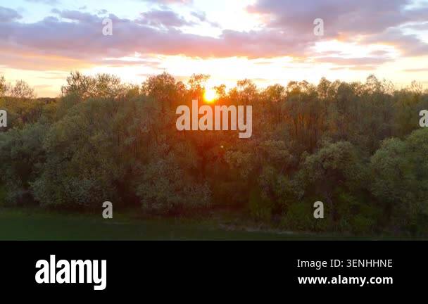 Aerial view of a vibrant sunset over a rural landscape, showcasing ...