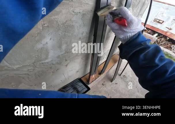 An unrecognizable person paints a wooden board with black paint. Close ...