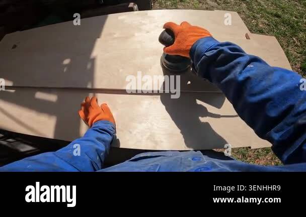 The master sands a wooden surface with an eccentric machine. The ...