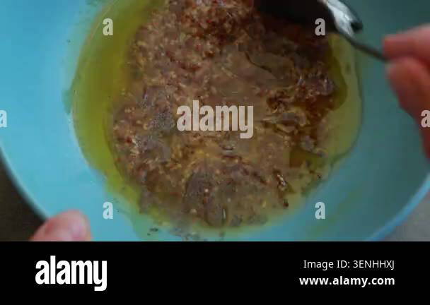 Close-up of whisking a delicious homemade mustard salad dressing inside ...