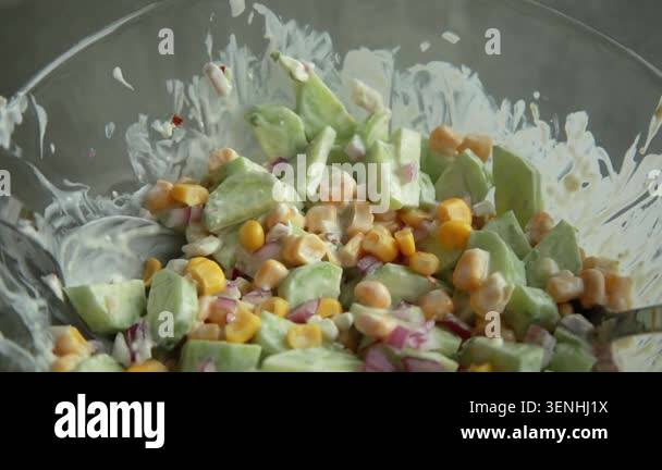 Close-up of a creamy summer salad with sweet corn, crisp cucumber, and ...