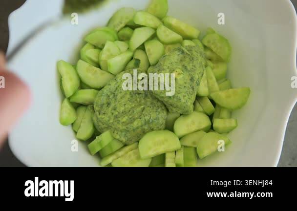 Close-up of a simple and healthy cucumber salad tossed with fresh dill ...
